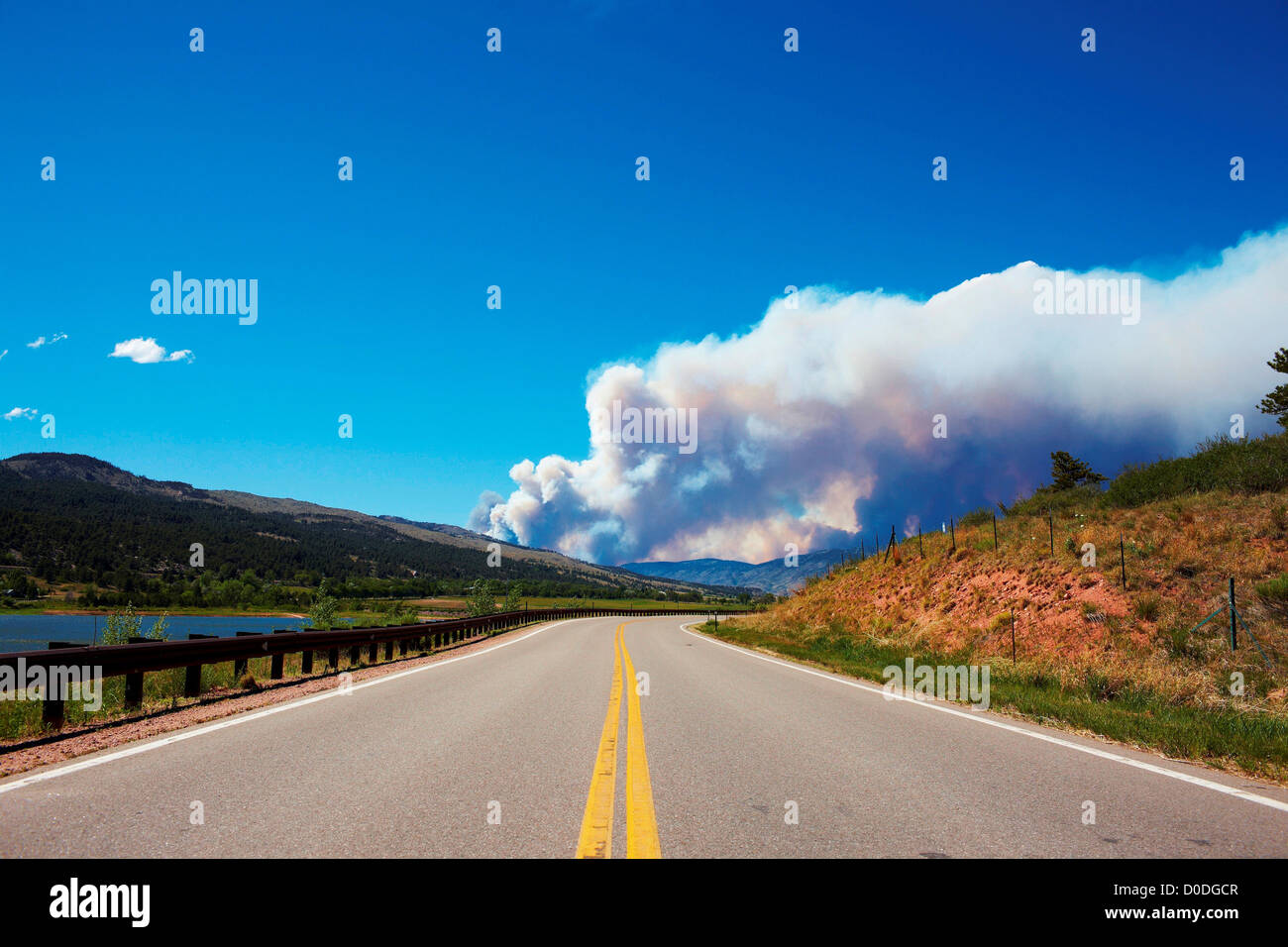 Road striking toward raging mountain wildfire, Colorado, USA Stock ...