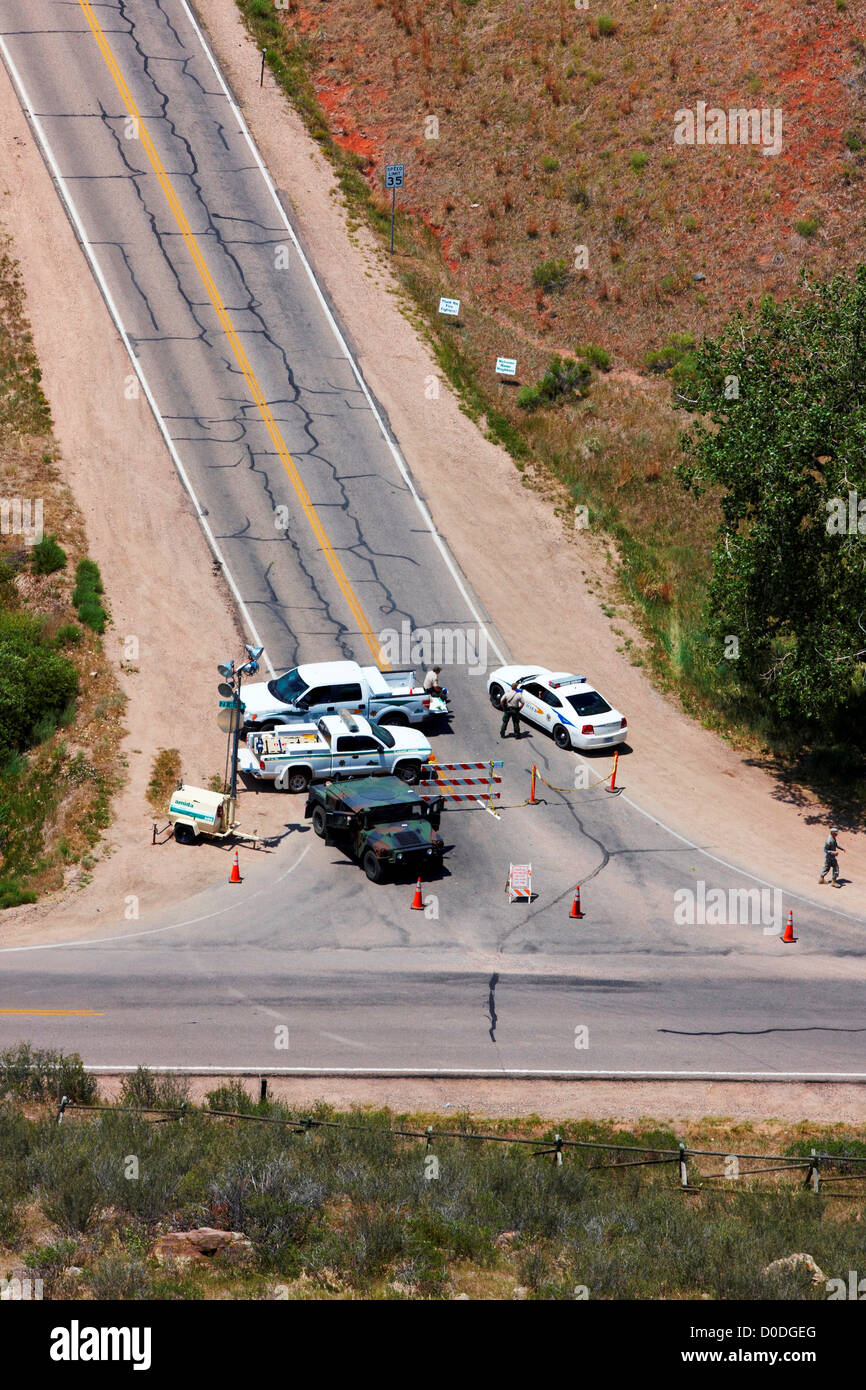 Emergency responders, including sheriff personnel, block a road during ...