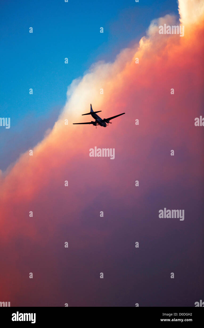 Heavy firefighting air tanker flies into dense smoke of a raging ...