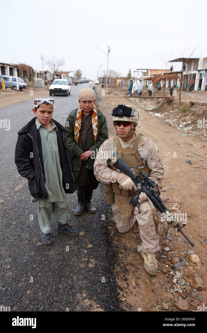 A United States Marine poses with Afghan children during a combat ...
