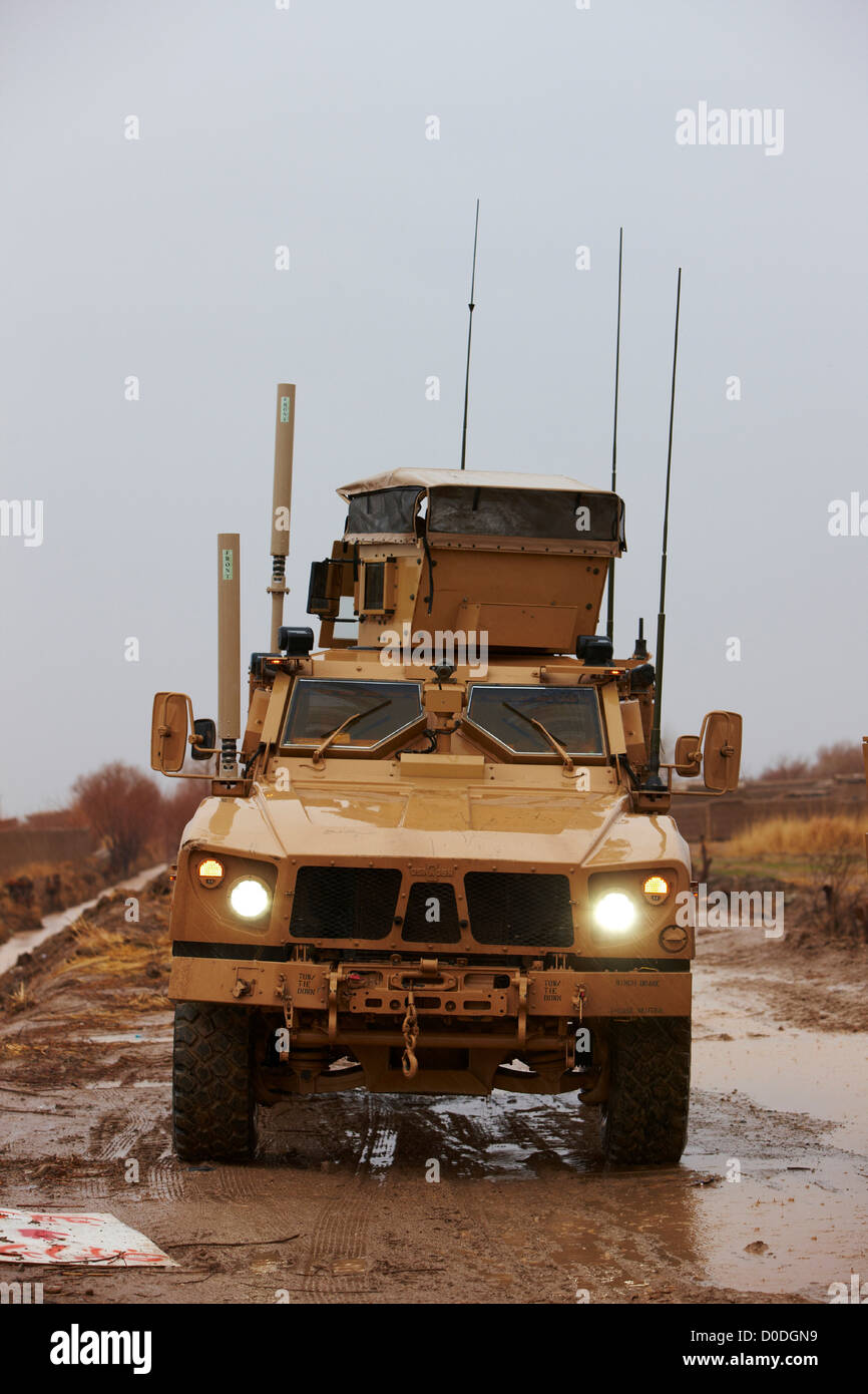 M-ATV, or Mine Resistant, Ambush Protected, All Terrain Vehicle, drives down muddy dirt road ...