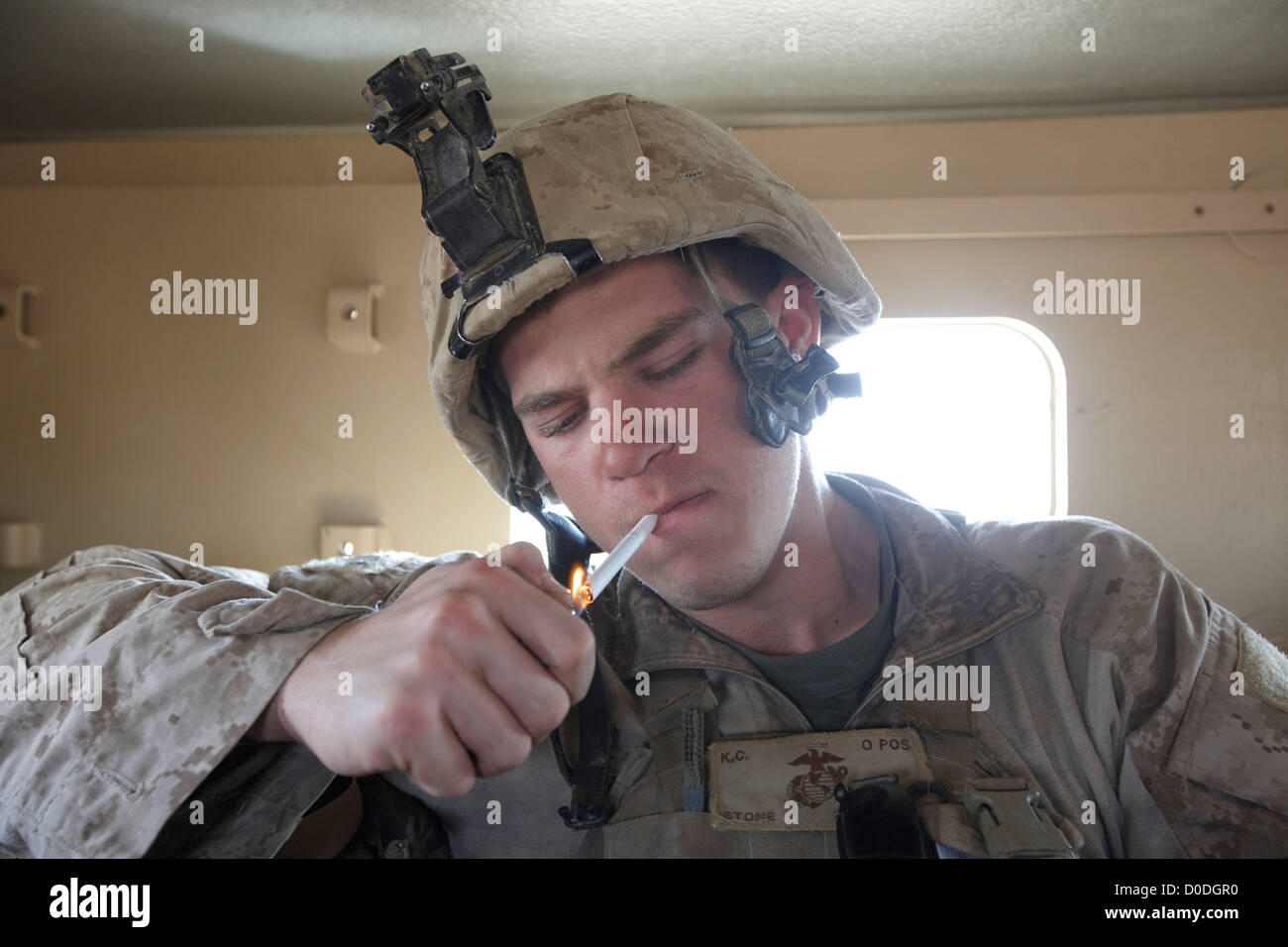 United States Marine smoking cigarette inside MRAP during a combat ...