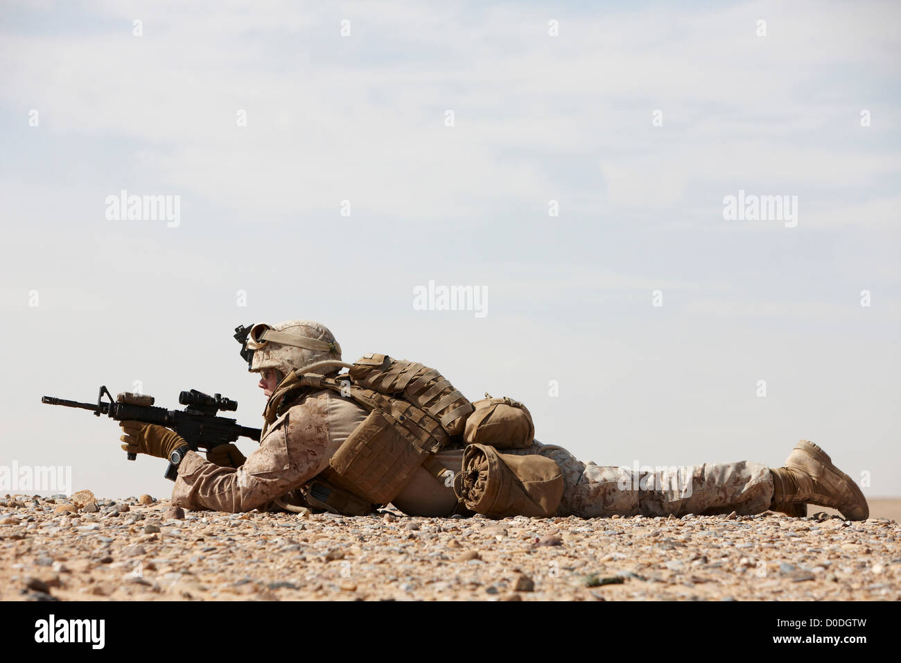 United States Marine aims an M4 carbine during a combat operation in ...