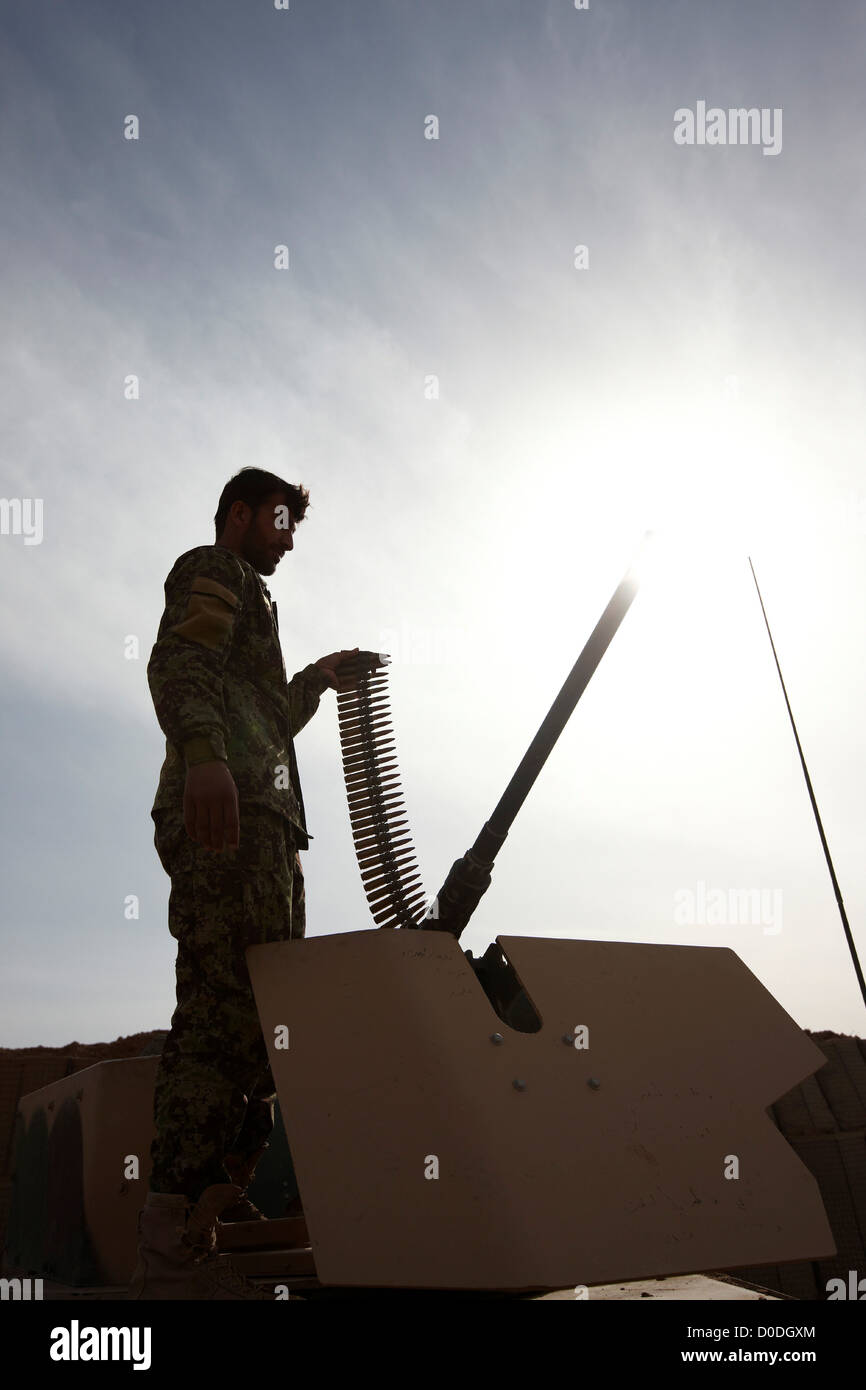 Silhouette Afghan National Army soldier loading belt .50 caliber ...