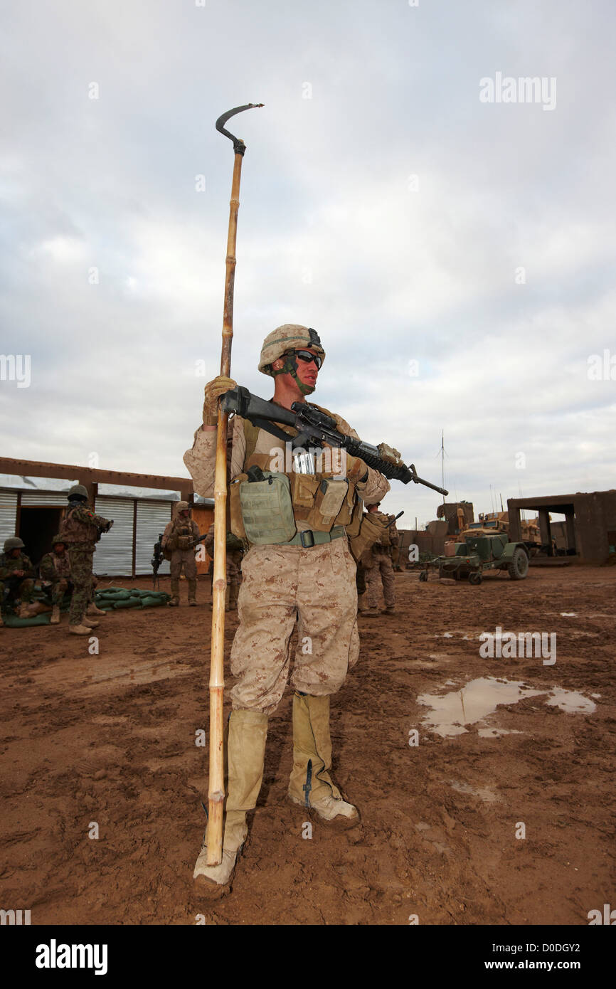 United States Marine with pole used to dig for hidden bombs and ...