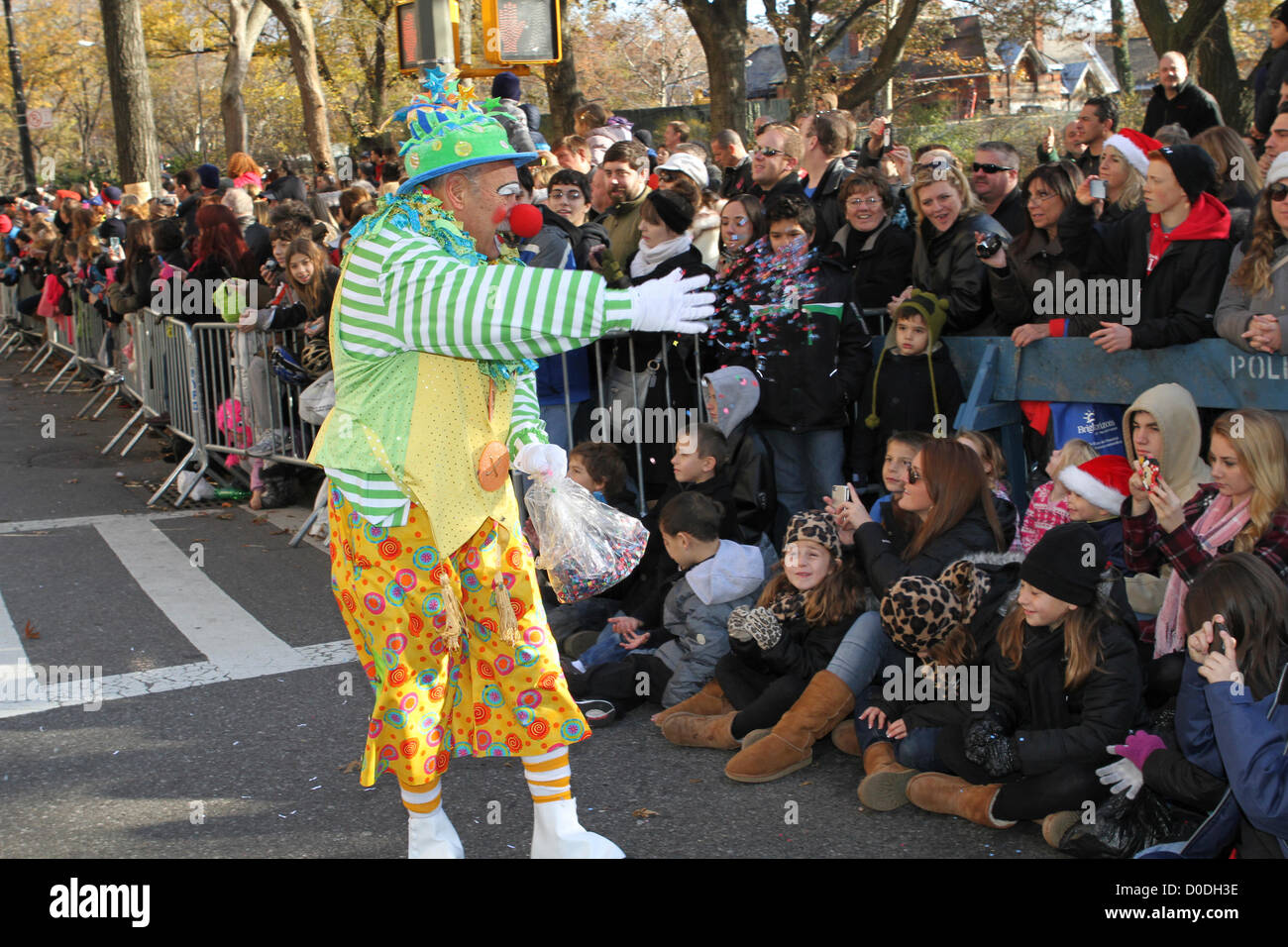 Clown tosses confetti at spectators on Central Park West during Macy's ...