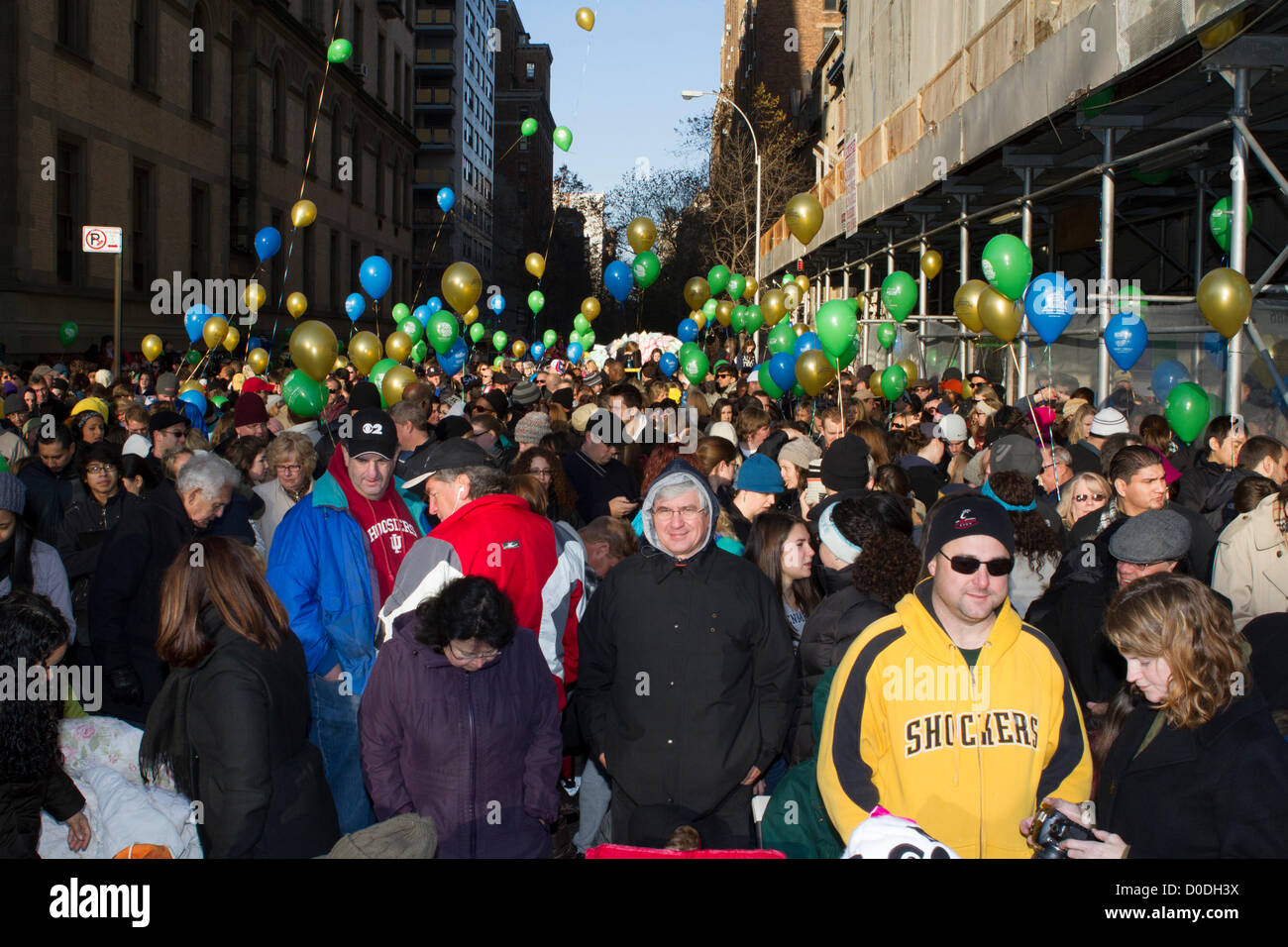 Spectators crowd side streets off Central Park West to catch a glimpse ...