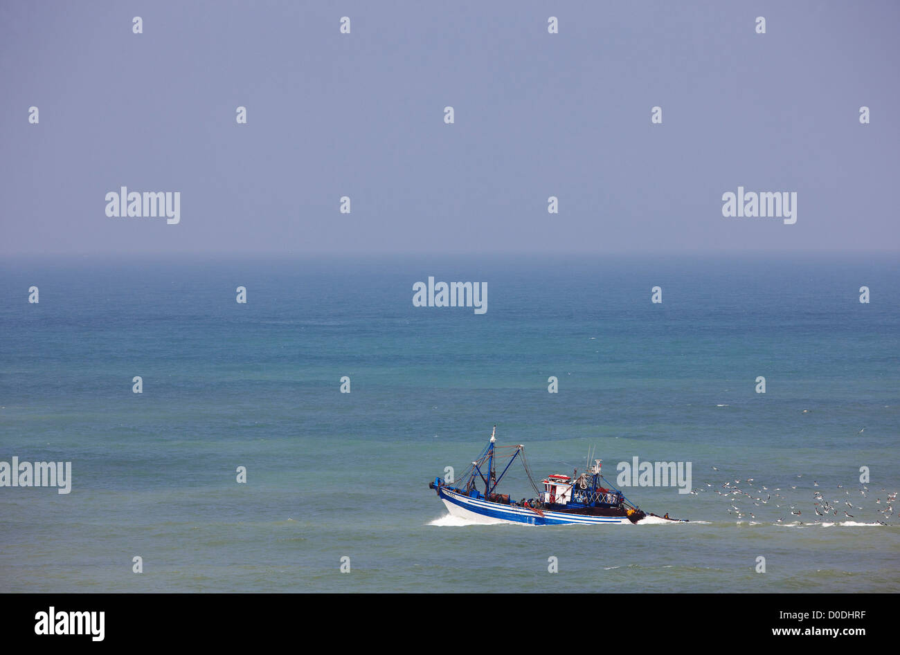 Fishing boat embarks into the Atlantic Ocean from the port at Tarfaya ...