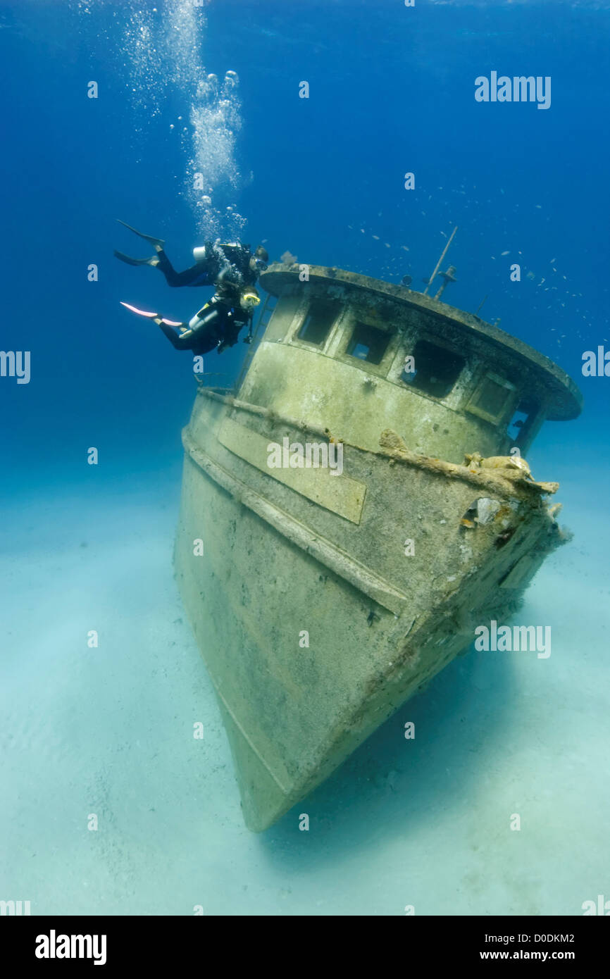 A Pair of Scuba Divers Approach the Captain Fox Tugboat Wreck Stock ...