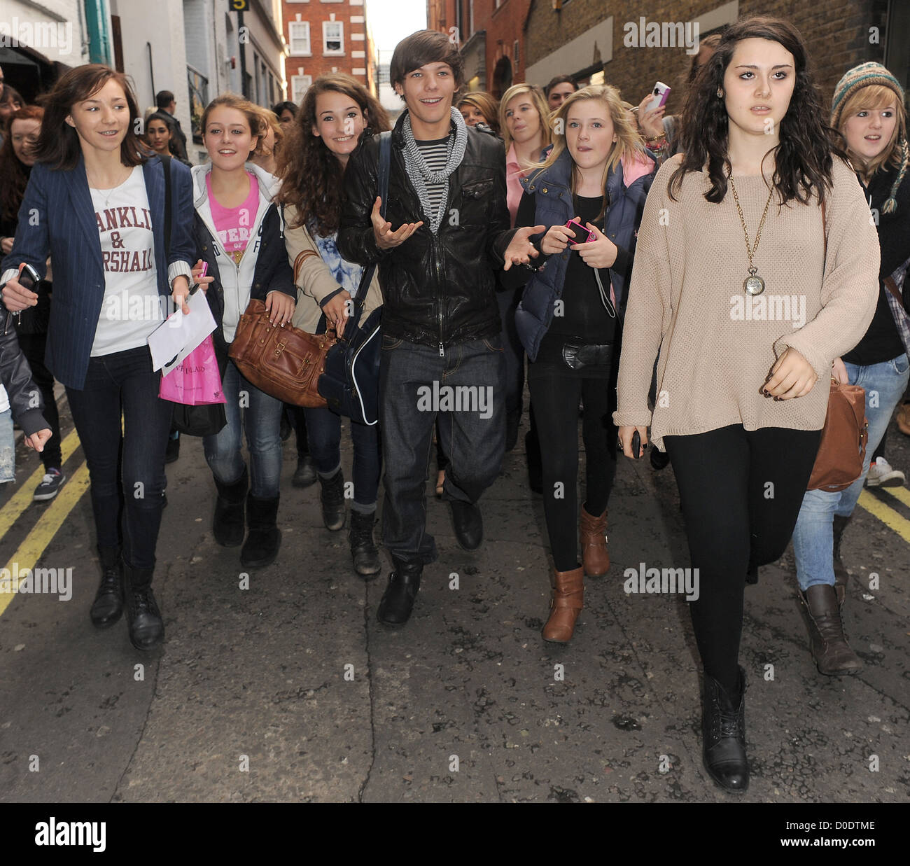 X Factor finalist Louis Tomlinson from boy band One Direction is mobbed ...