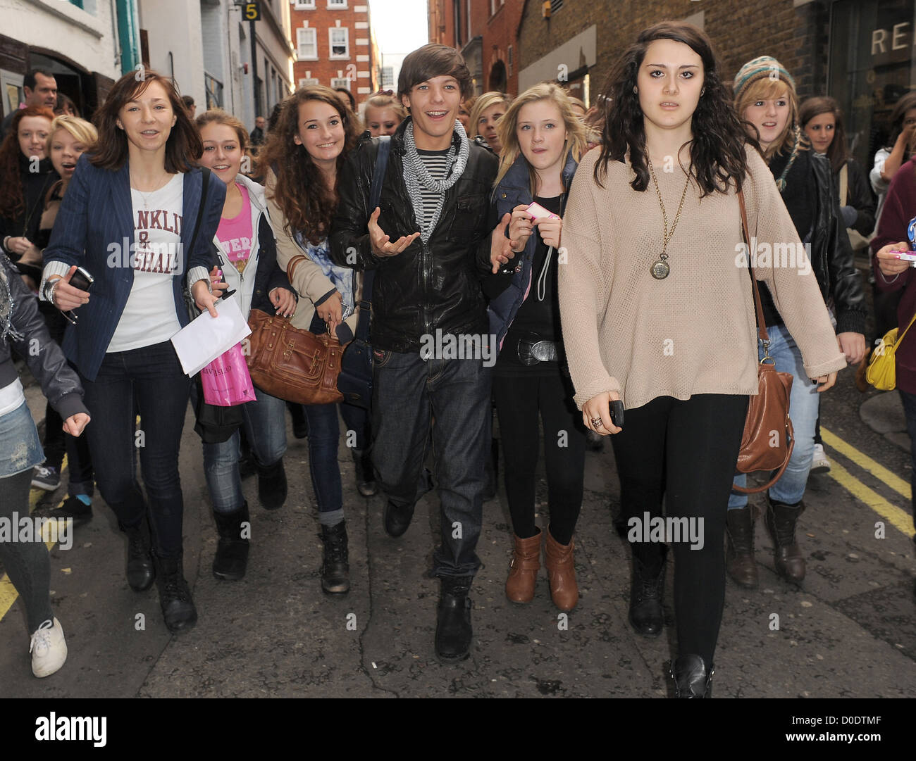 X Factor finalist Louis Tomlinson from boy band One Direction is mobbed ...