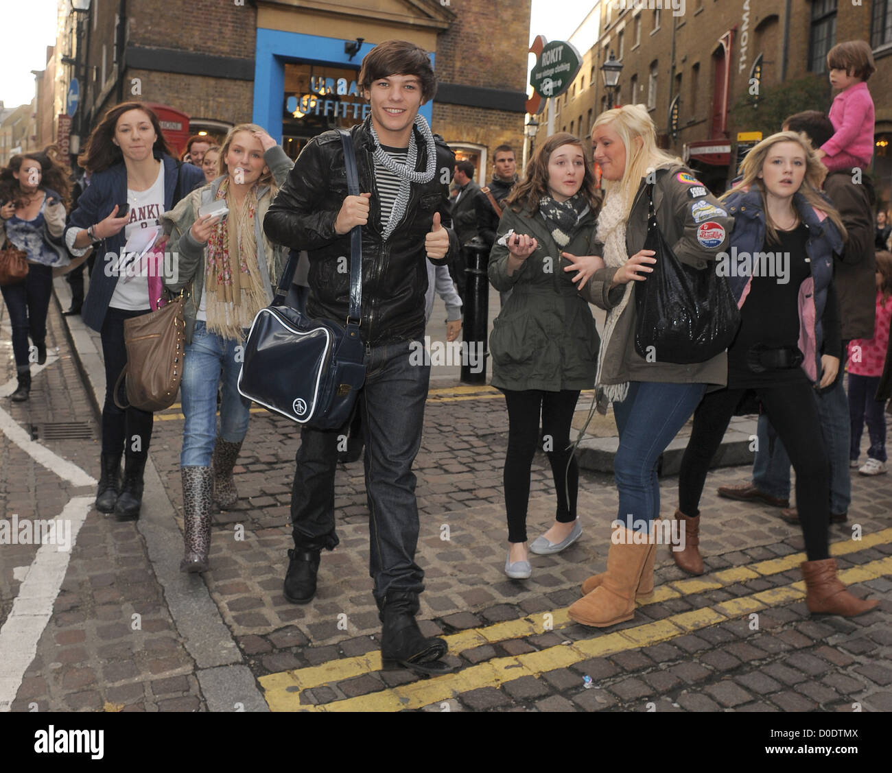 X Factor finalist Louis Tomlinson from boy band One Direction is mobbed ...