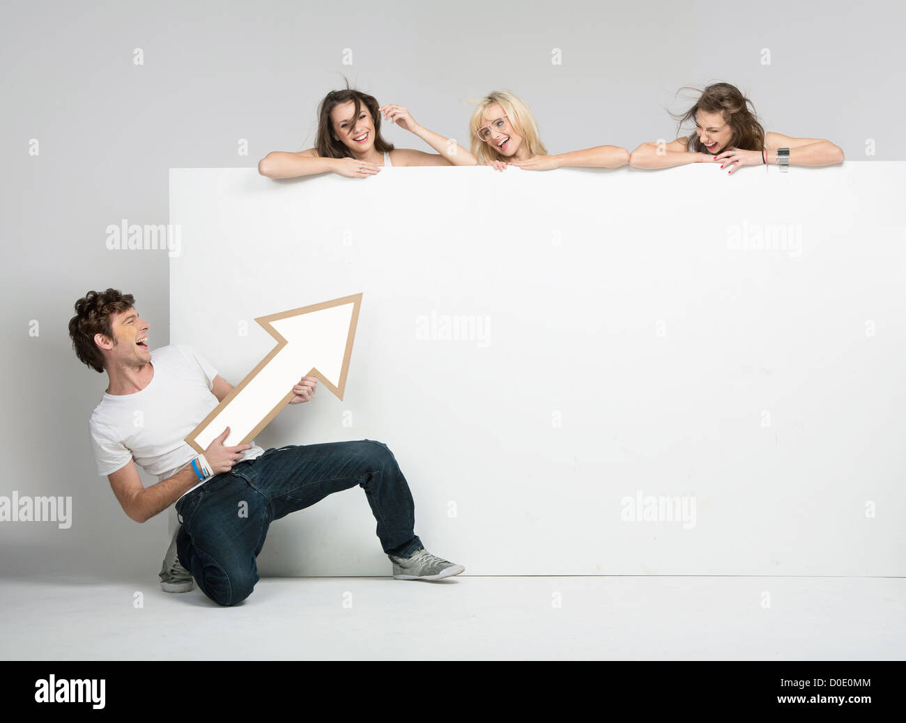 Young handsome man pointing at advert Stock Photo - Alamy