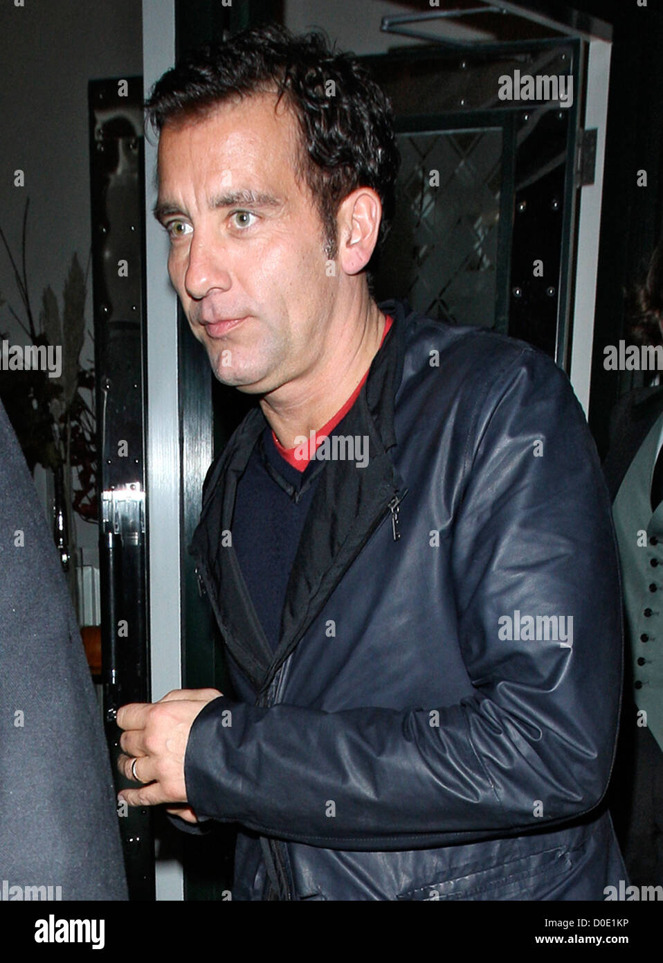 Clive Owen tries to hide behind his friends as he left the Ivy Club ...