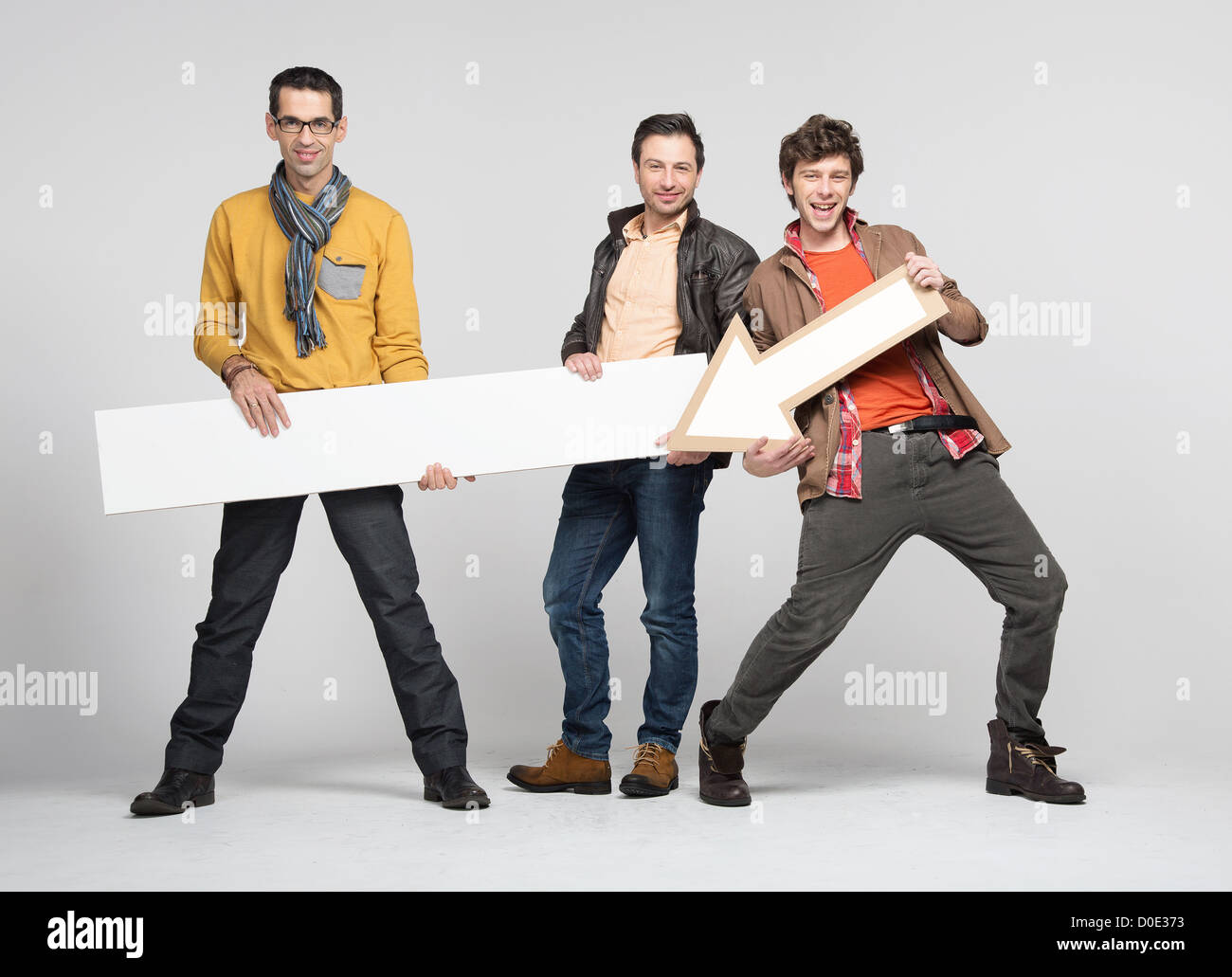 Three handsome man with arrow Stock Photo - Alamy