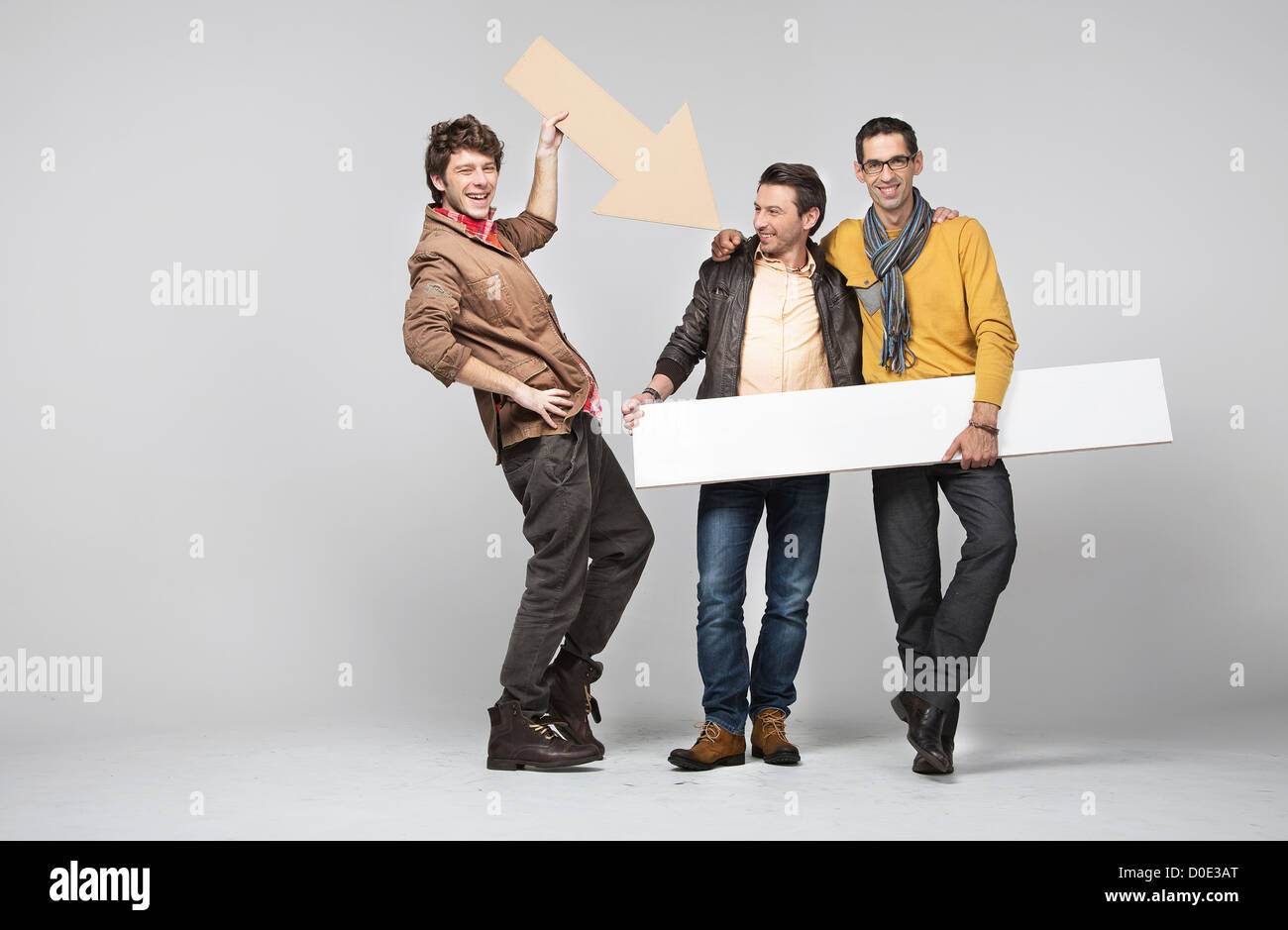 A band of male young friends with signs Stock Photo - Alamy