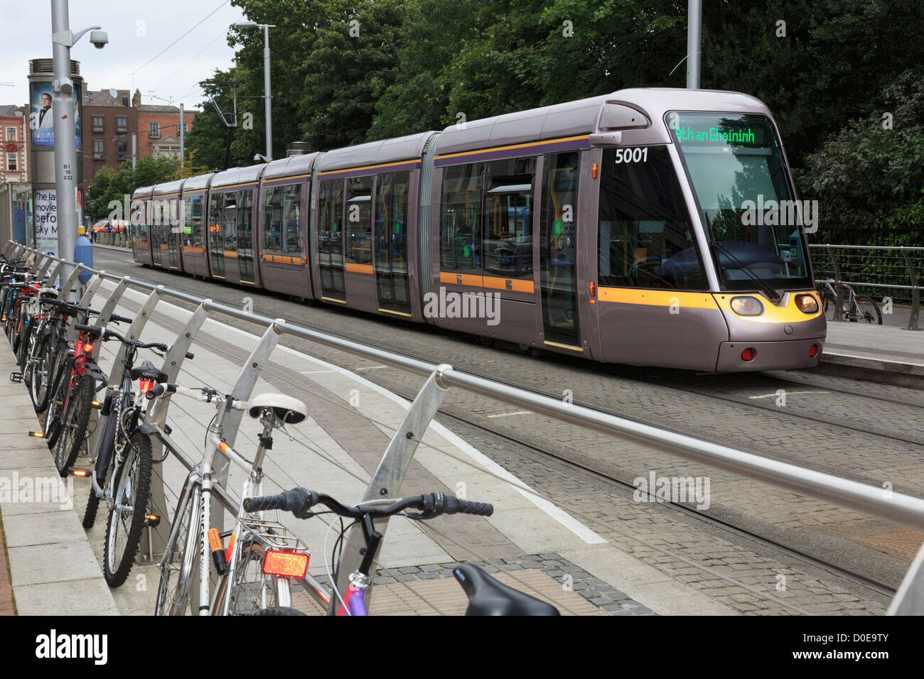 Luas Light Rail System tram in city centre station with bikes chained ...
