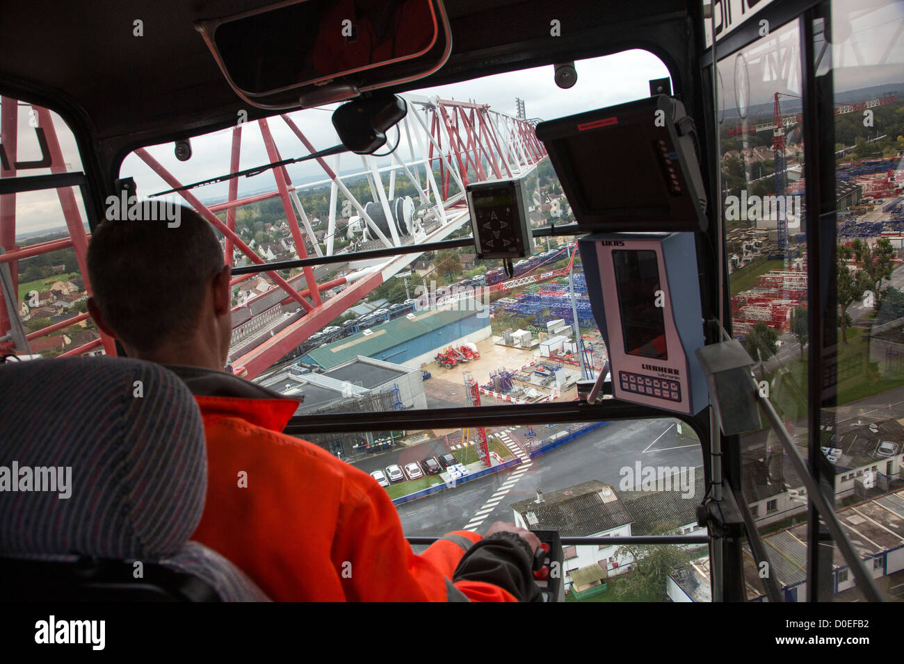 CRANE OPERATOR ON A CONSTRUCTION SITE AT THE CONTROLS OF HIS CRANE ...