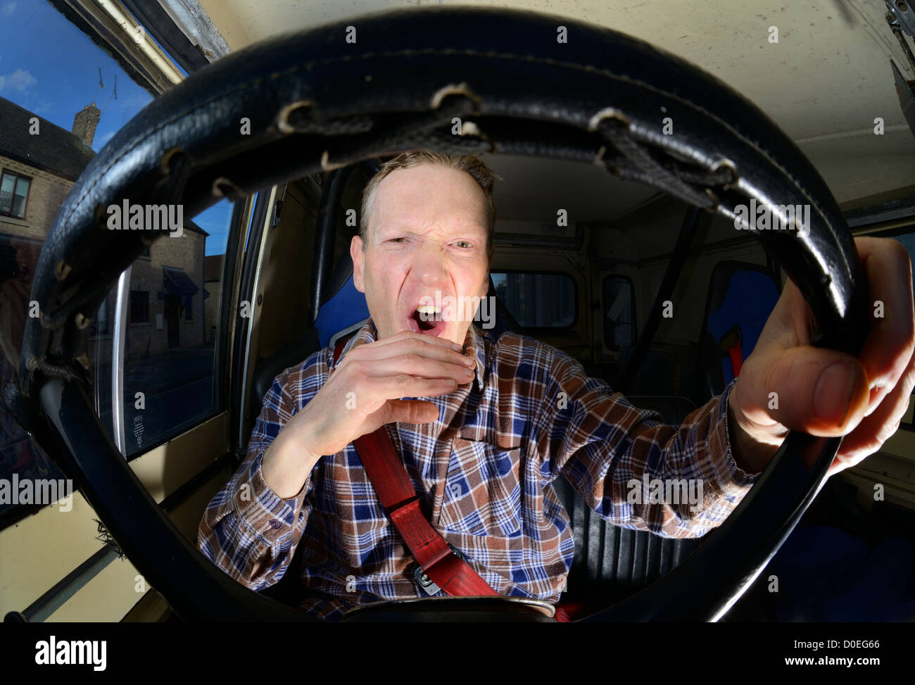 tired driver yawning driving vehicle Stock Photo - Alamy