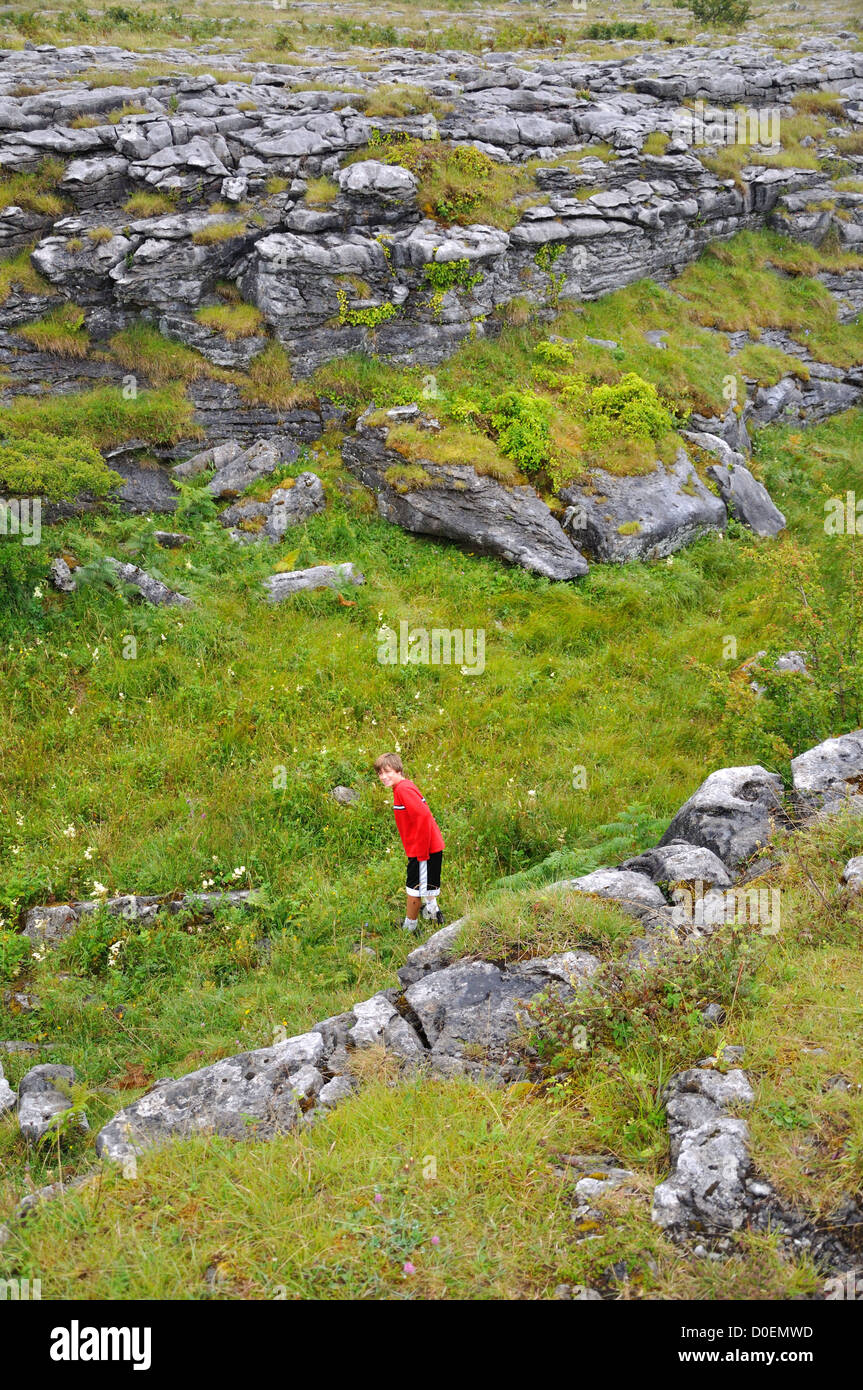 A Teenage Boy hikes in the Karst rock formations The Burren Ireland ...
