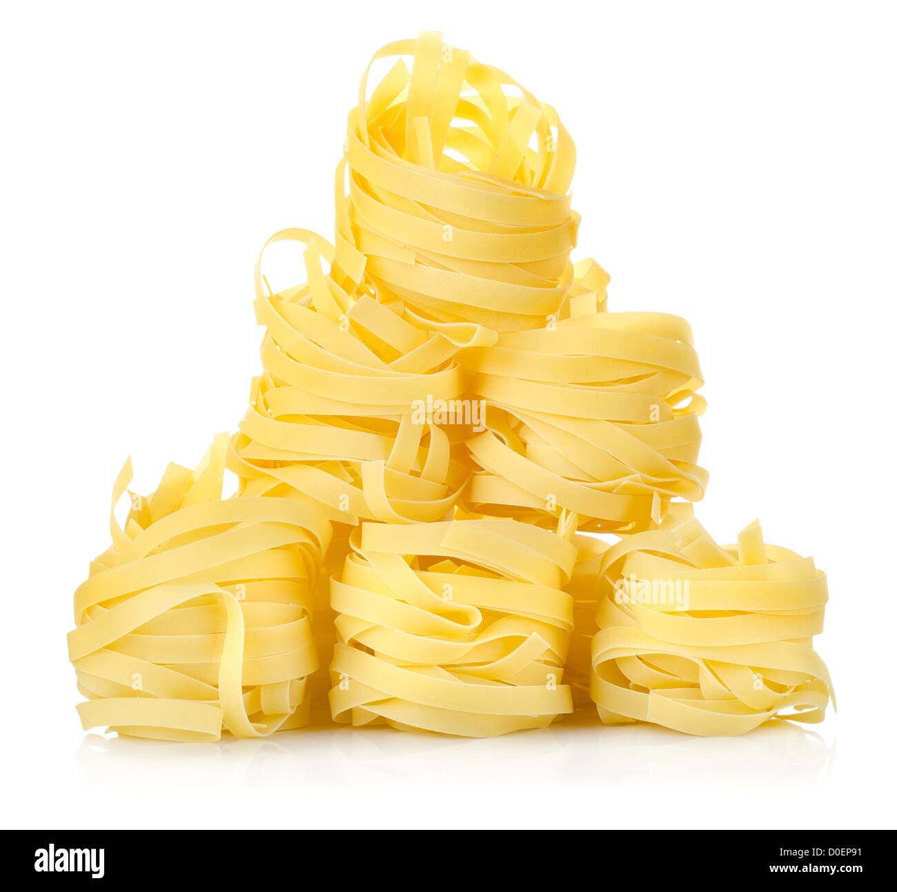 Pile of pasta tagliatelle isolated on white background Stock Photo - Alamy