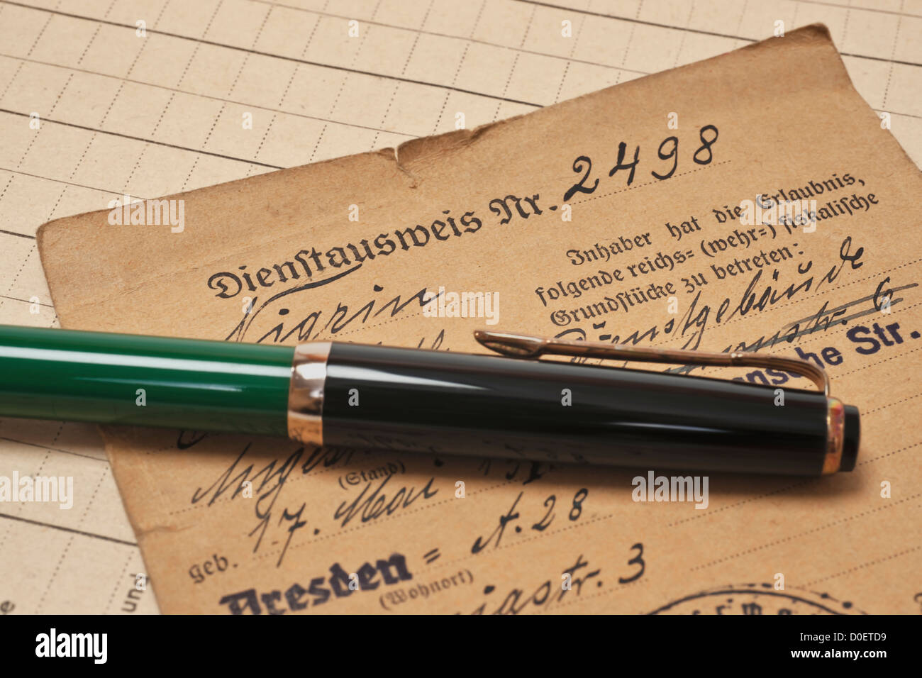 Detail photo of a Official Identification Paper, a pen lies alongside ...