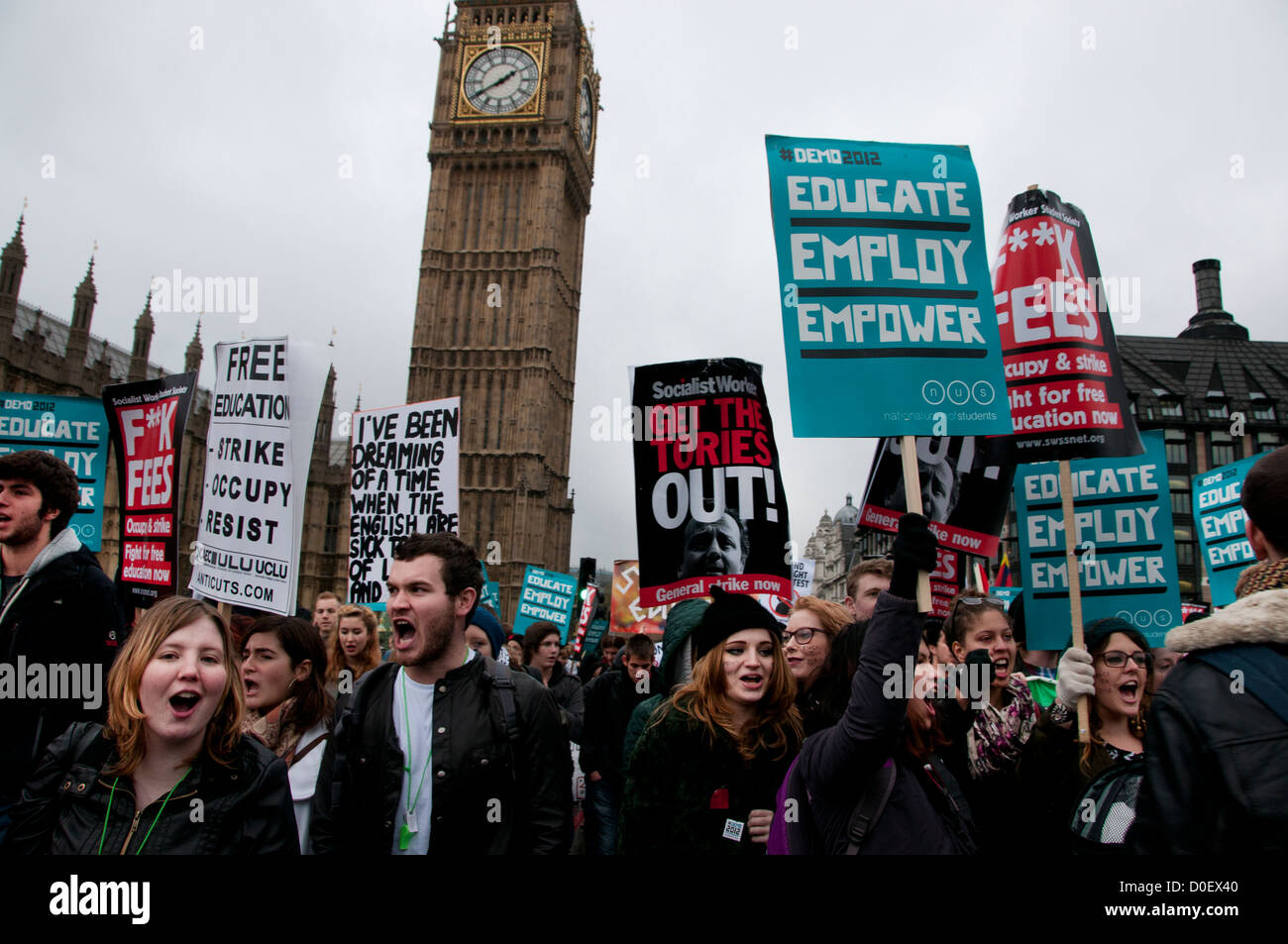 A group of students stand shouting in front of Big Ben with placards ...