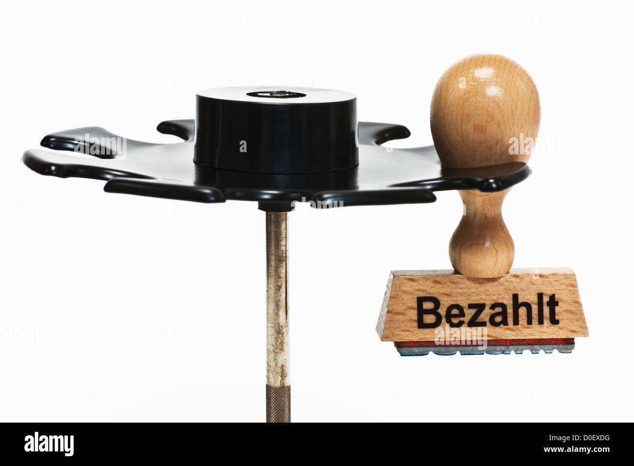 Stamp with German inscription Bezahlt (paid) hangs in a stamp rack ...