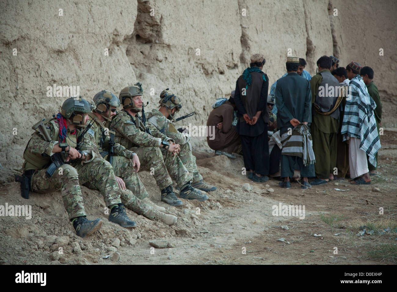 US Special forces watch as Afghan Local Policemen and villagers crowd ...