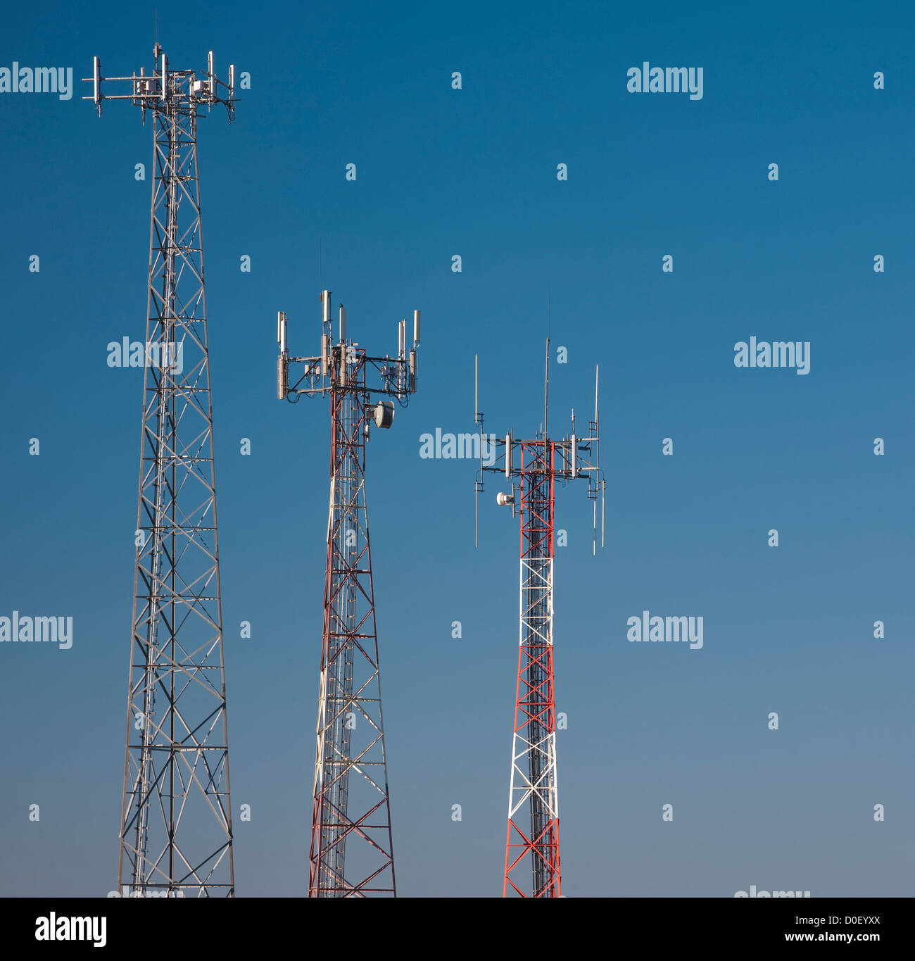 Three communication towers and blue sky Stock Photo - Alamy
