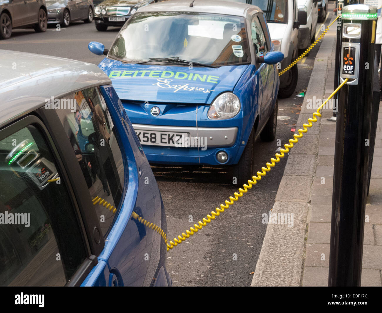 Electric car charging in street in London Stock Photo - Alamy