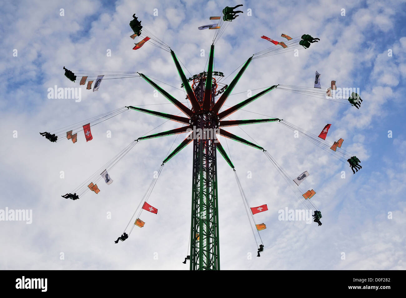 People enjoying a sunny fall afternoon on a amusement park ride at the ...