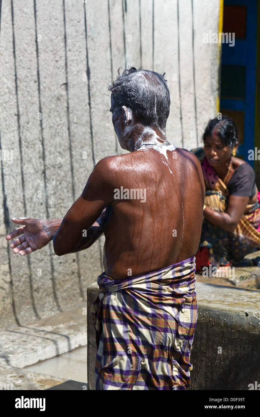 Worker washing himself in the open Air Laundry Dhobi Ghat in Mumbai ...