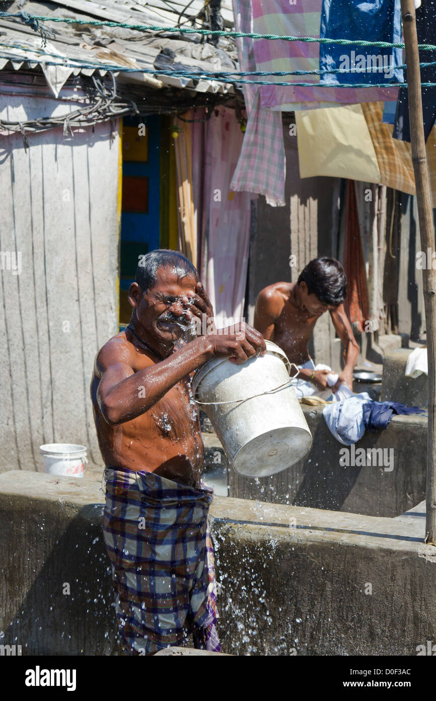 Worker washing himself in the open Air Laundry Dhobi Ghat in Mumbai ...