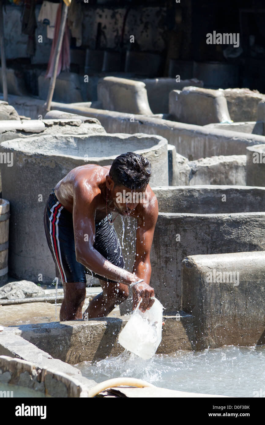 Worker washing himself in the open Air Laundry Dhobi Ghat in Mumbai ...