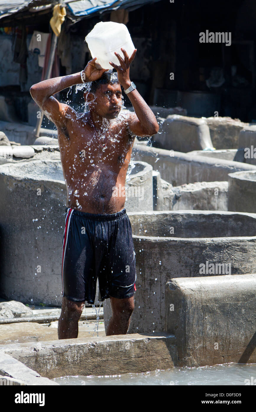 Worker washing himself in the open Air Laundry Dhobi Ghat in Mumbai ...