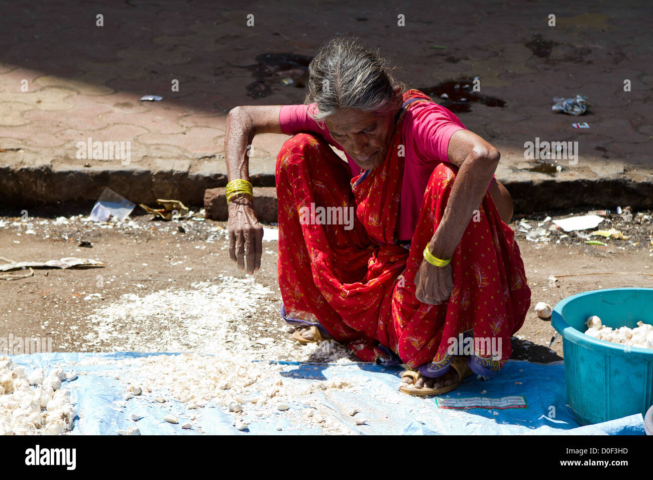 Old woman drying grains hi-res stock photography and images - Alamy