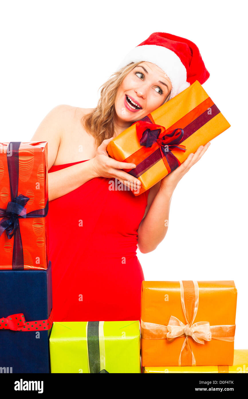 Young surprised Christmas woman exploring gift boxes, isolated on white ...
