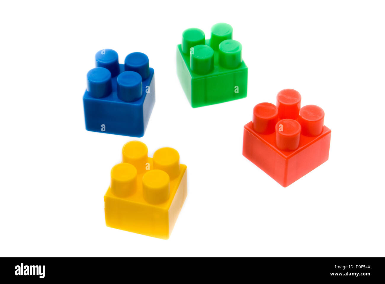Bright red yellow green and blue child's building bricks on white ...