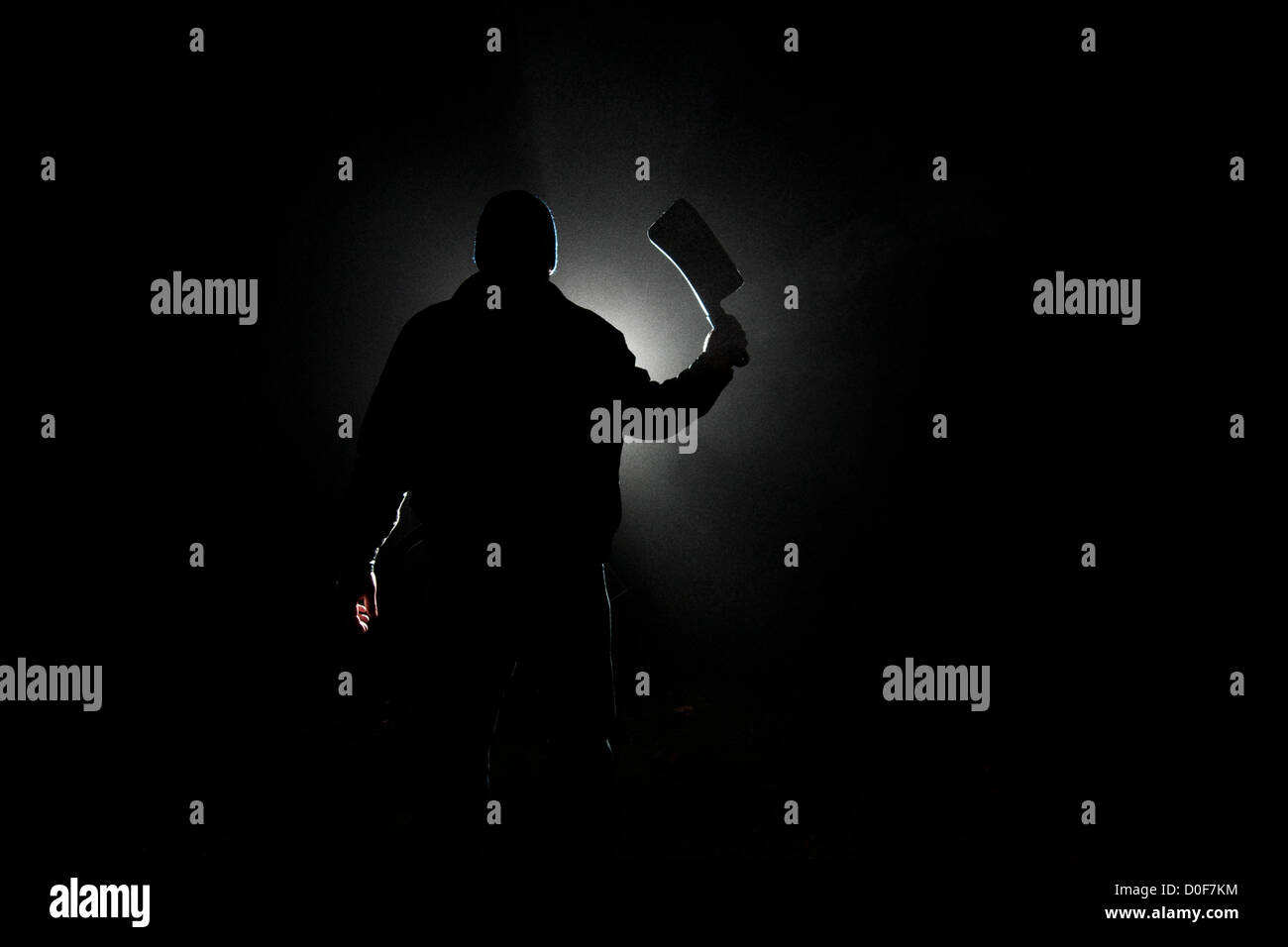 Cleaver Killer: Dark, foggy outdoor silhouette of a man wielding a ...