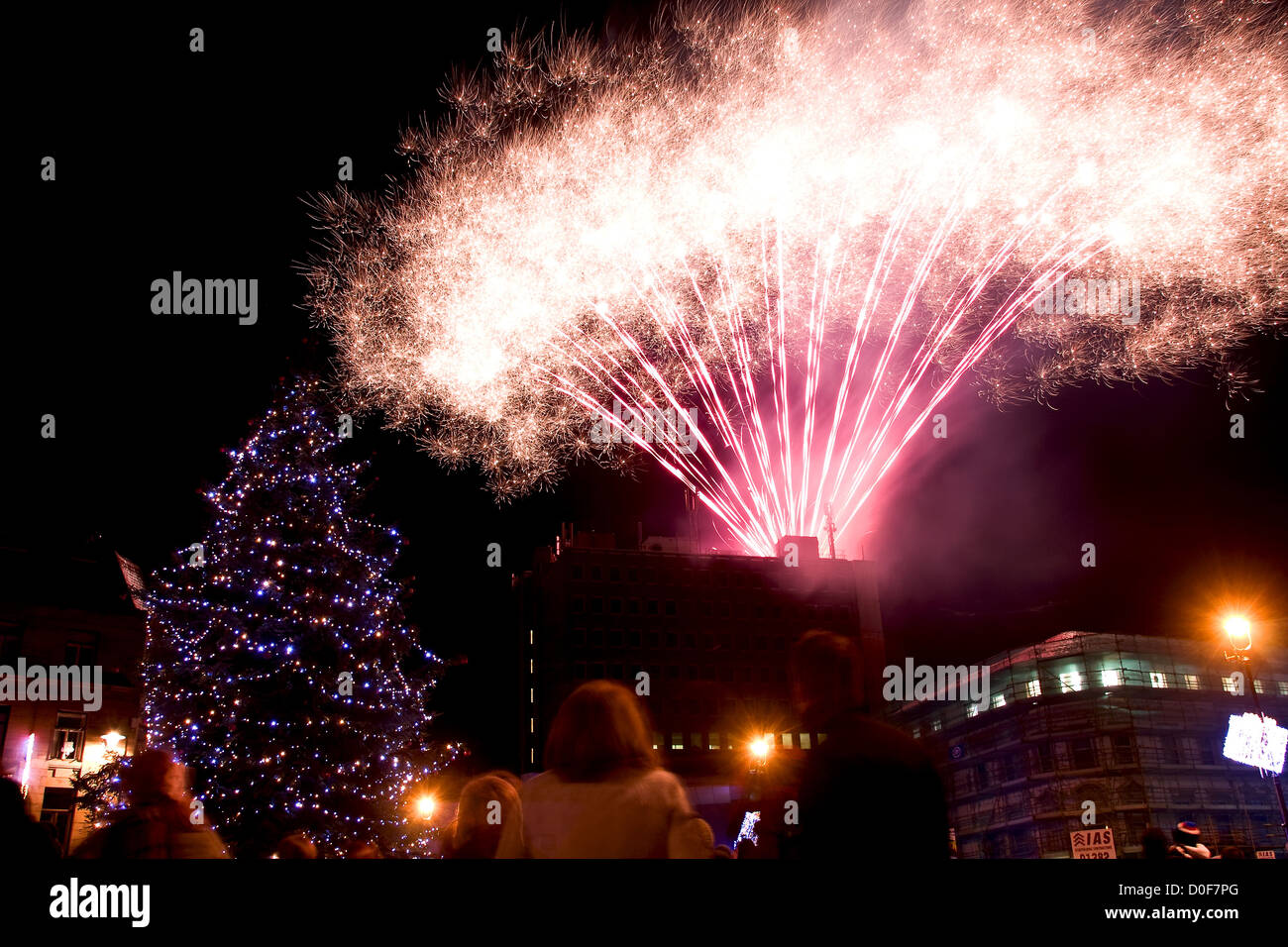 People looking at the Fireworks exploding and filling up the night sky ...