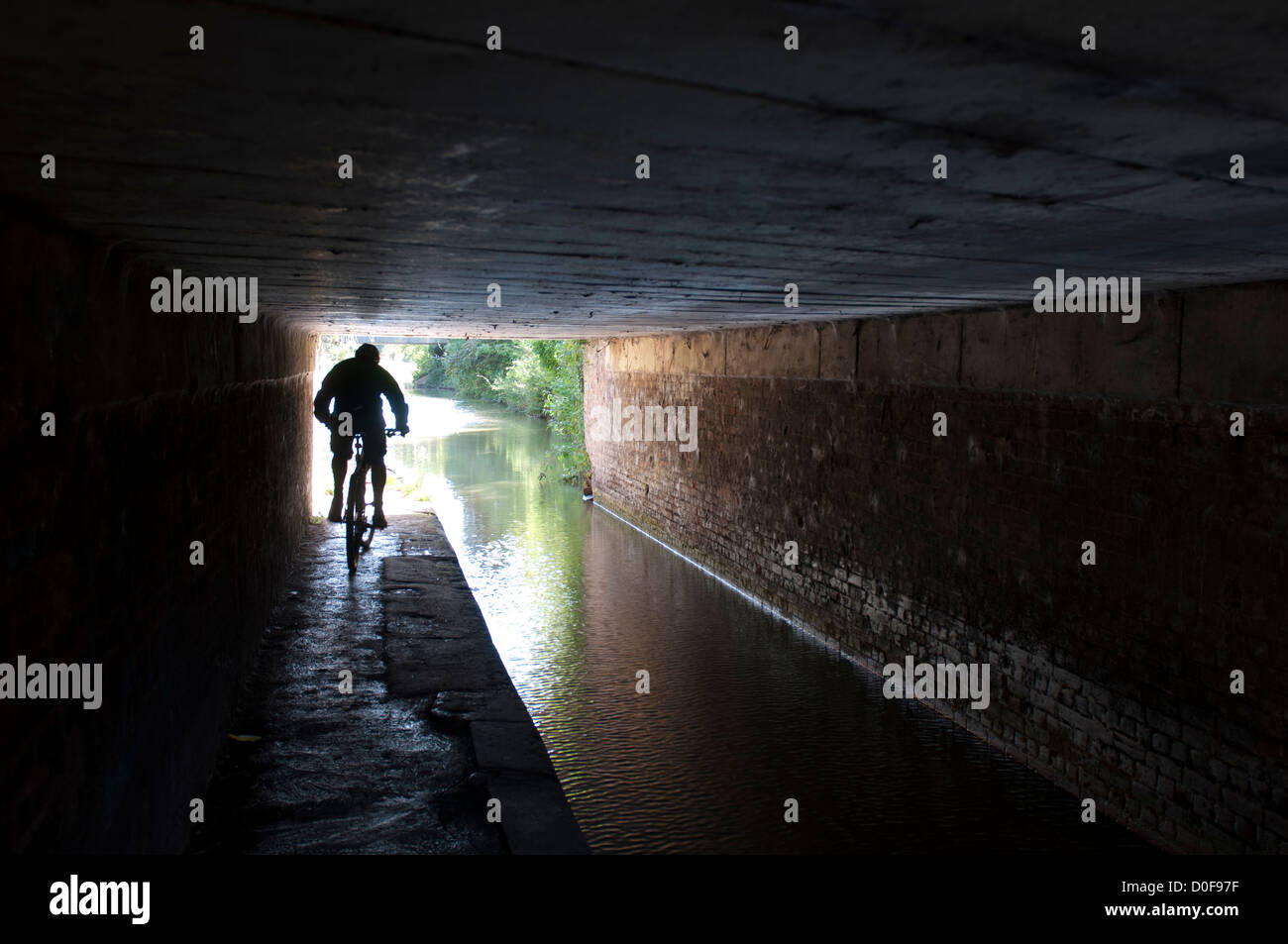 Cyclist riding under bridge hi-res stock photography and images - Alamy