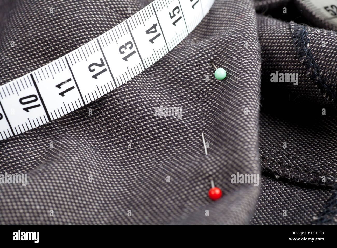 Pins and measuring tape on fabric, ready for sewing Stock Photo - Alamy