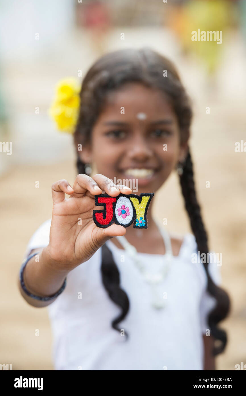 Smiling Indian girl holding a JOY multicoloured embroidery patch. India ...