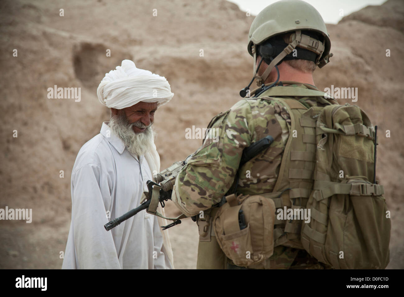 A US soldier speaks with a villager during an Afghan National Security ...