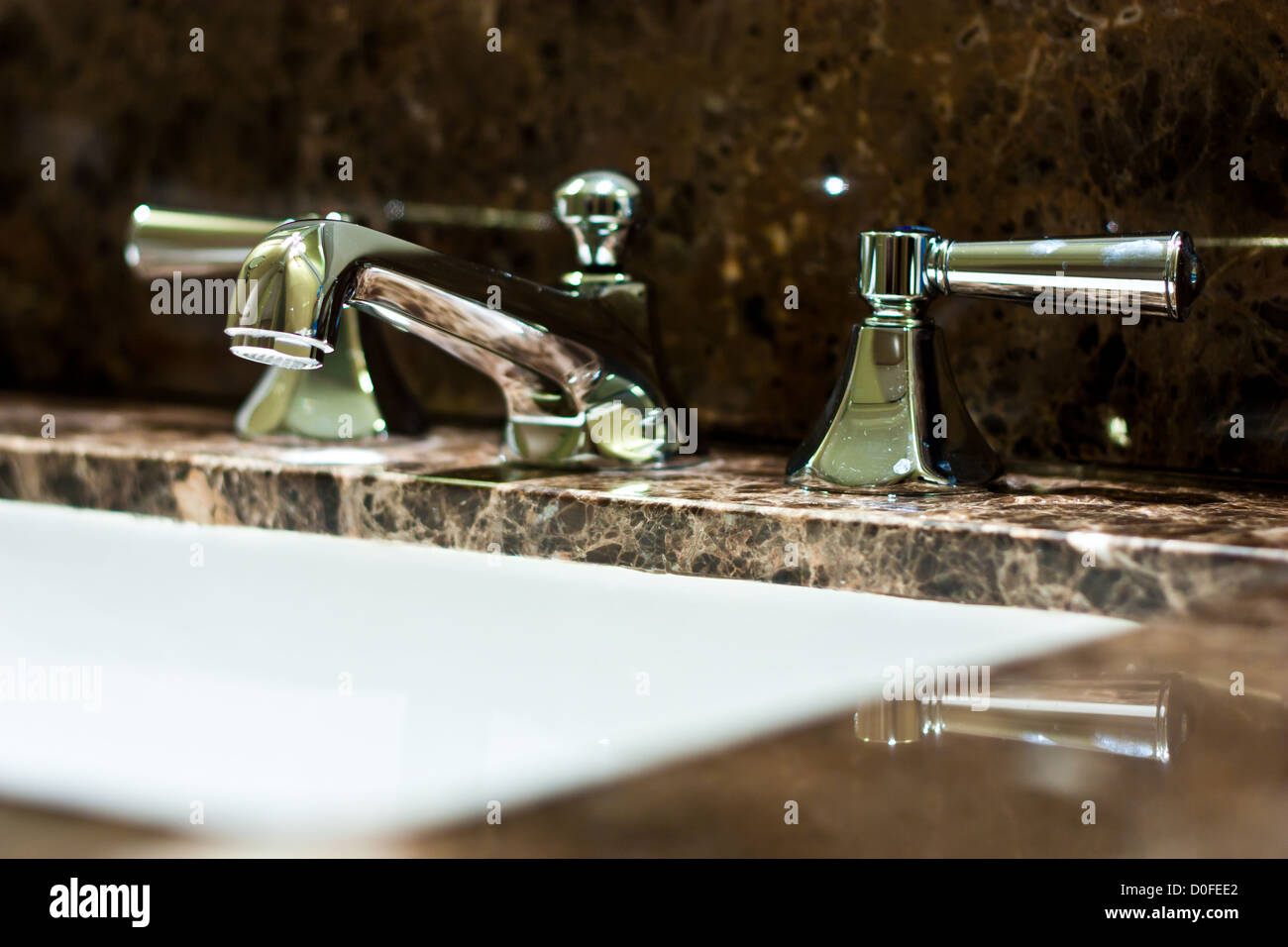 Tap in an Italian luxury hotel, steel on marble Stock Photo - Alamy
