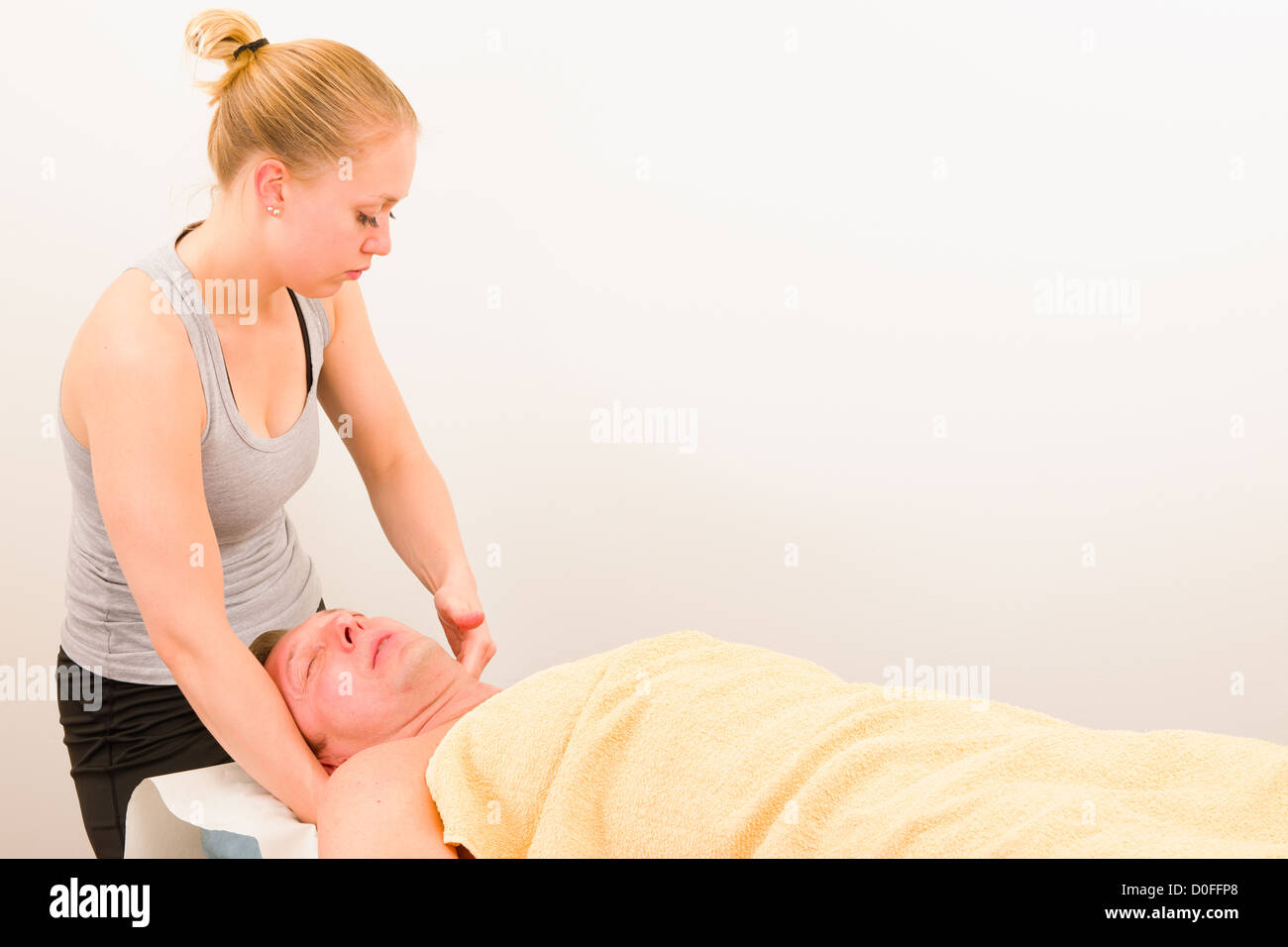 A masseur is massaging a customer's neck Stock Photo - Alamy