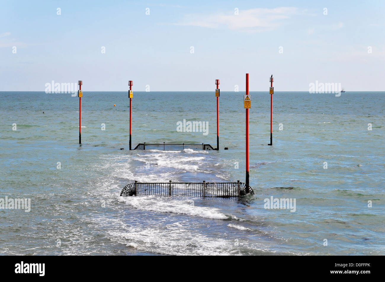 Poles with warning signs in the sea Stock Photo - Alamy