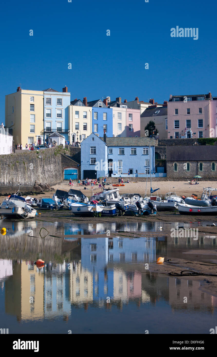 Tenby Harbour at low tide with pastel coloured houses reflected in ...