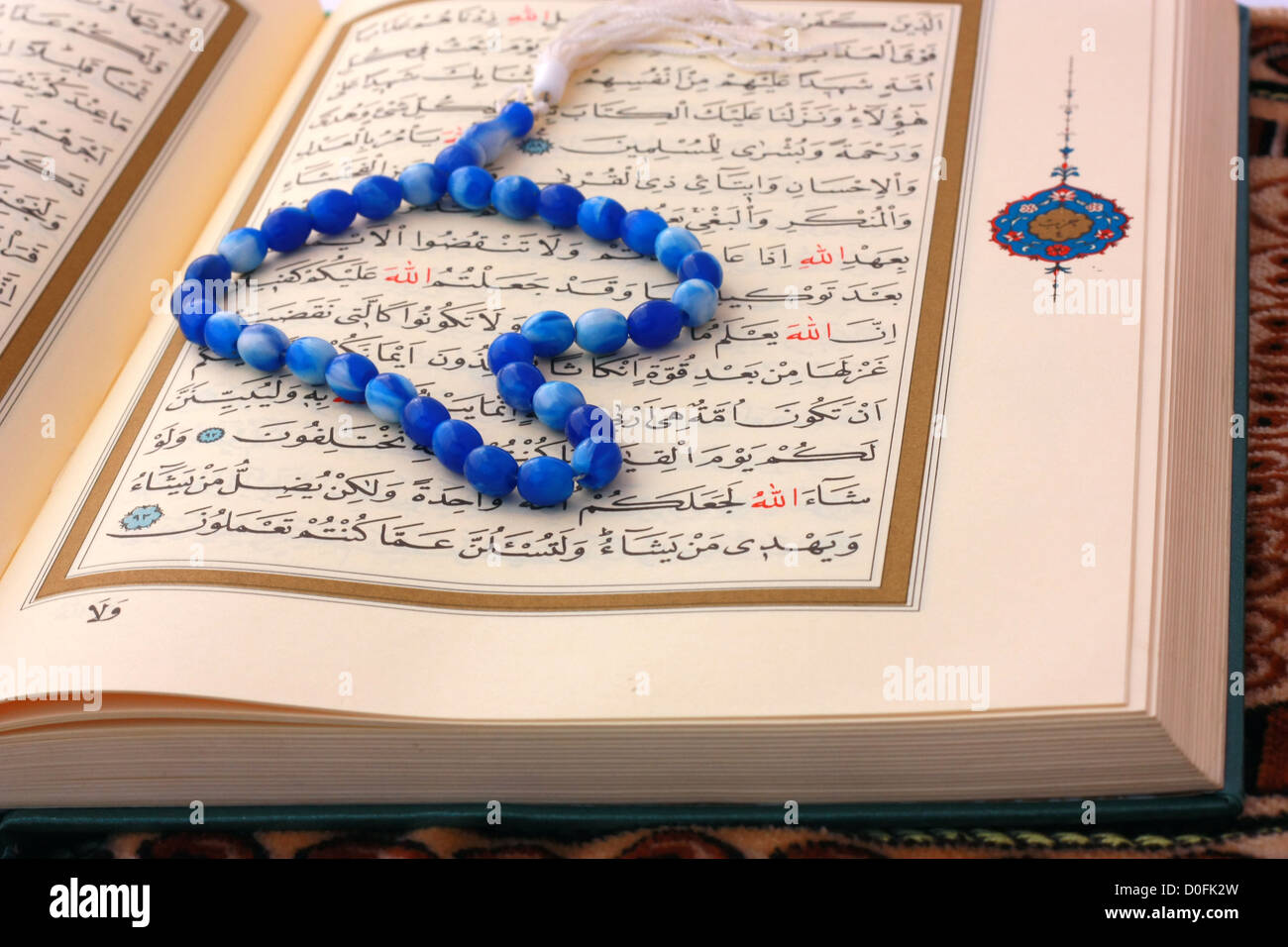 The Holy Koran page with blue rosary Stock Photo - Alamy